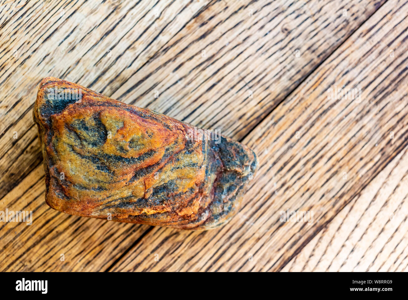 Colorful rainbow stone on rustic wood background Stock Photo - Alamy