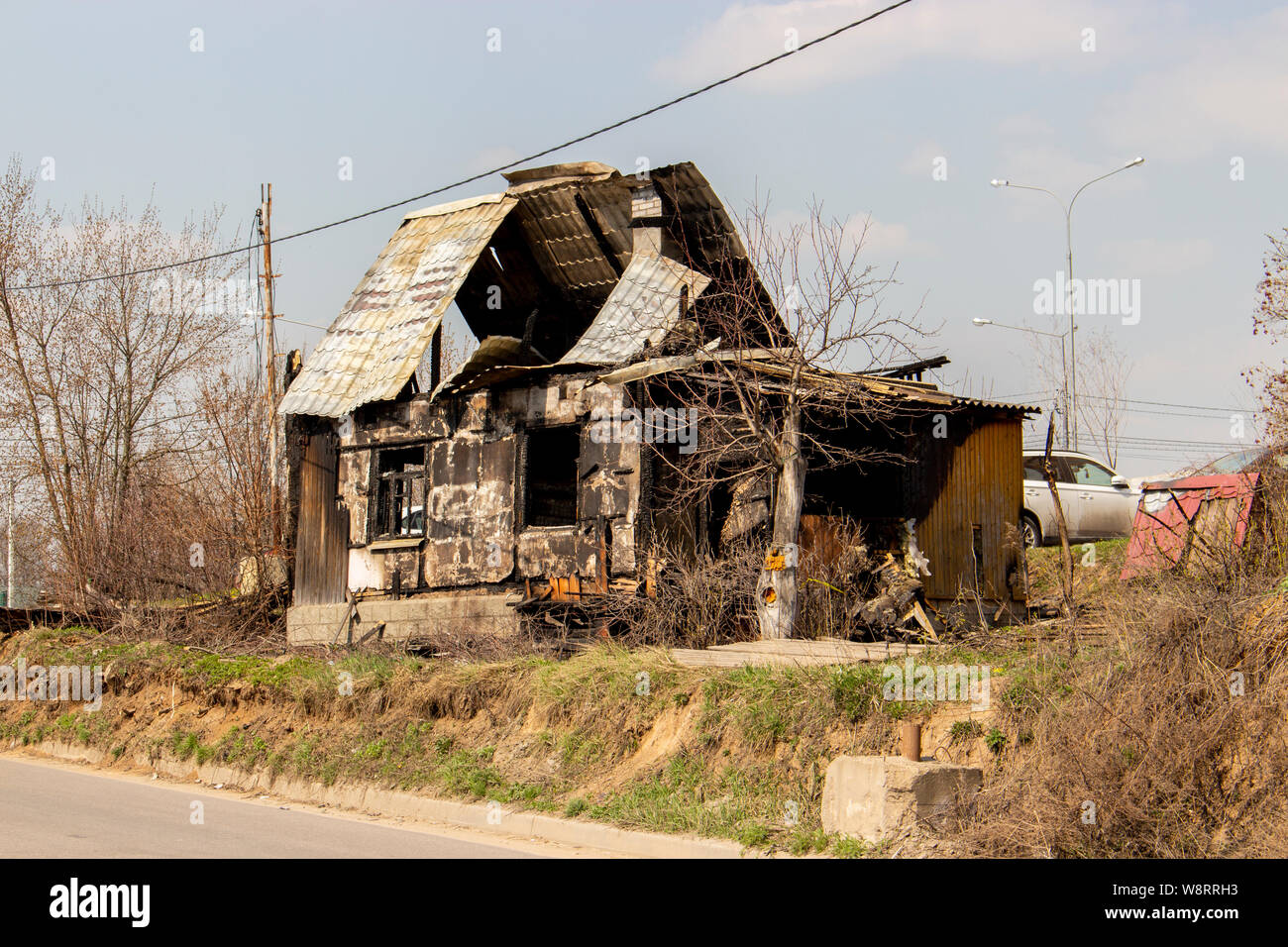 The skeleton of a burnt wooden house, a dwelling house after a fire ...