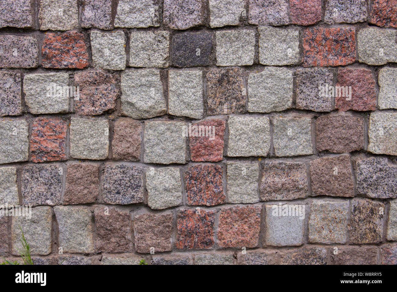Pieces of cobblestones bricks cubes of granite red gray pink black ...