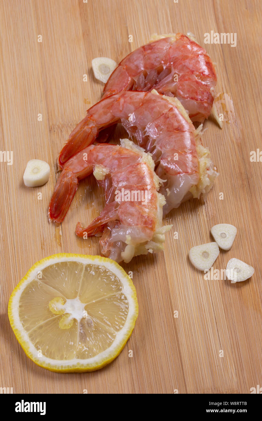 Fresh pink prawn shrimp without heads, shrimp stuffed with garlic ...