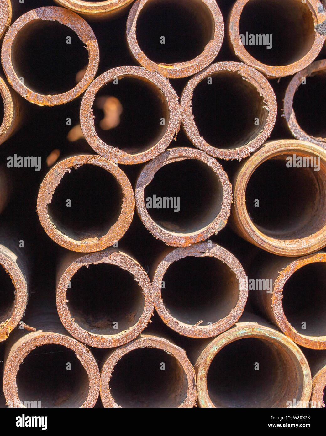 Rusty metal pipes from the butt, texture background, building material ...