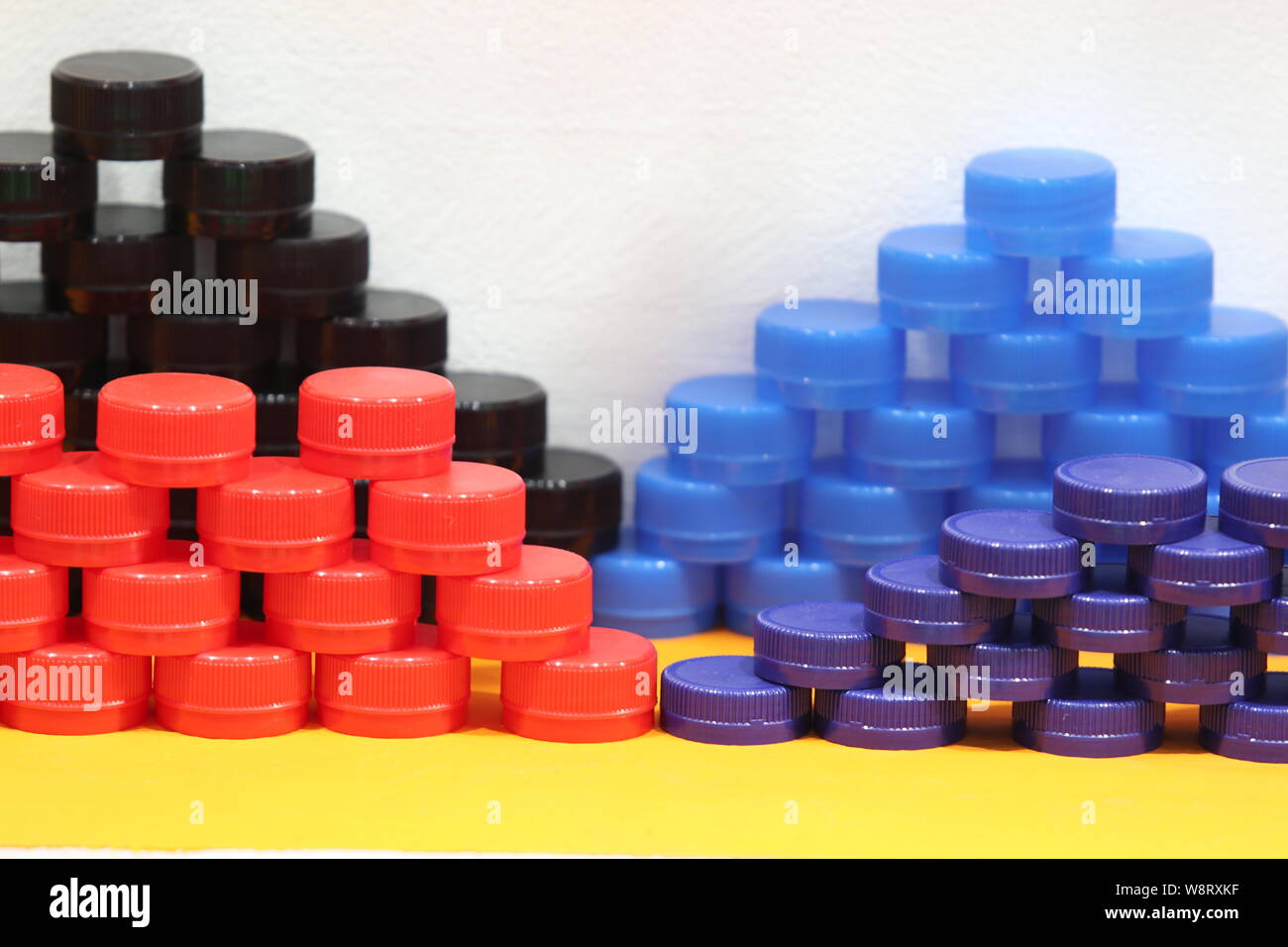Plastic bottle caps ; white green pink orange colors ; showing Stock ...