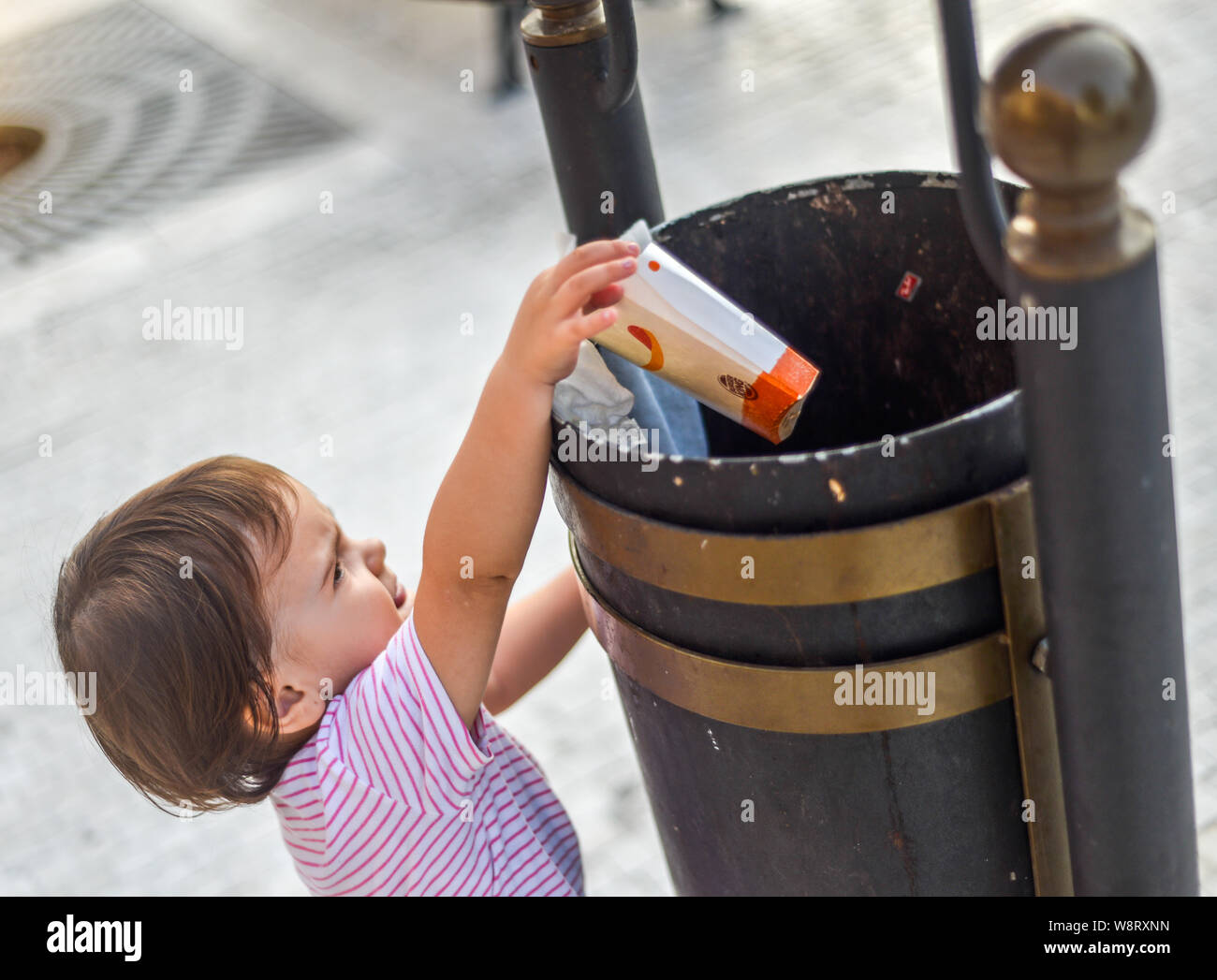Child dropping litter hi-res stock photography and images - Alamy