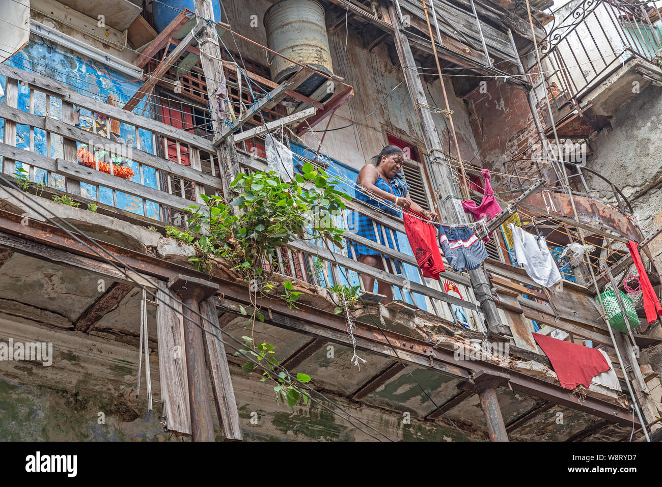 Havana, Cuba - April 09, 2019: woman on a balcony of a depressed ...