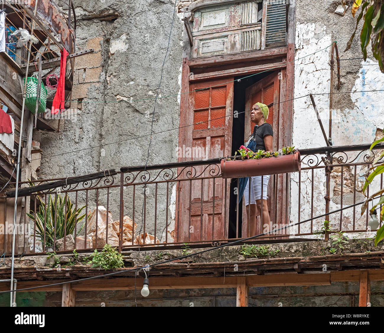 Havana, Cuba - April 09, 2019: woman on a balcony of a depressed ...