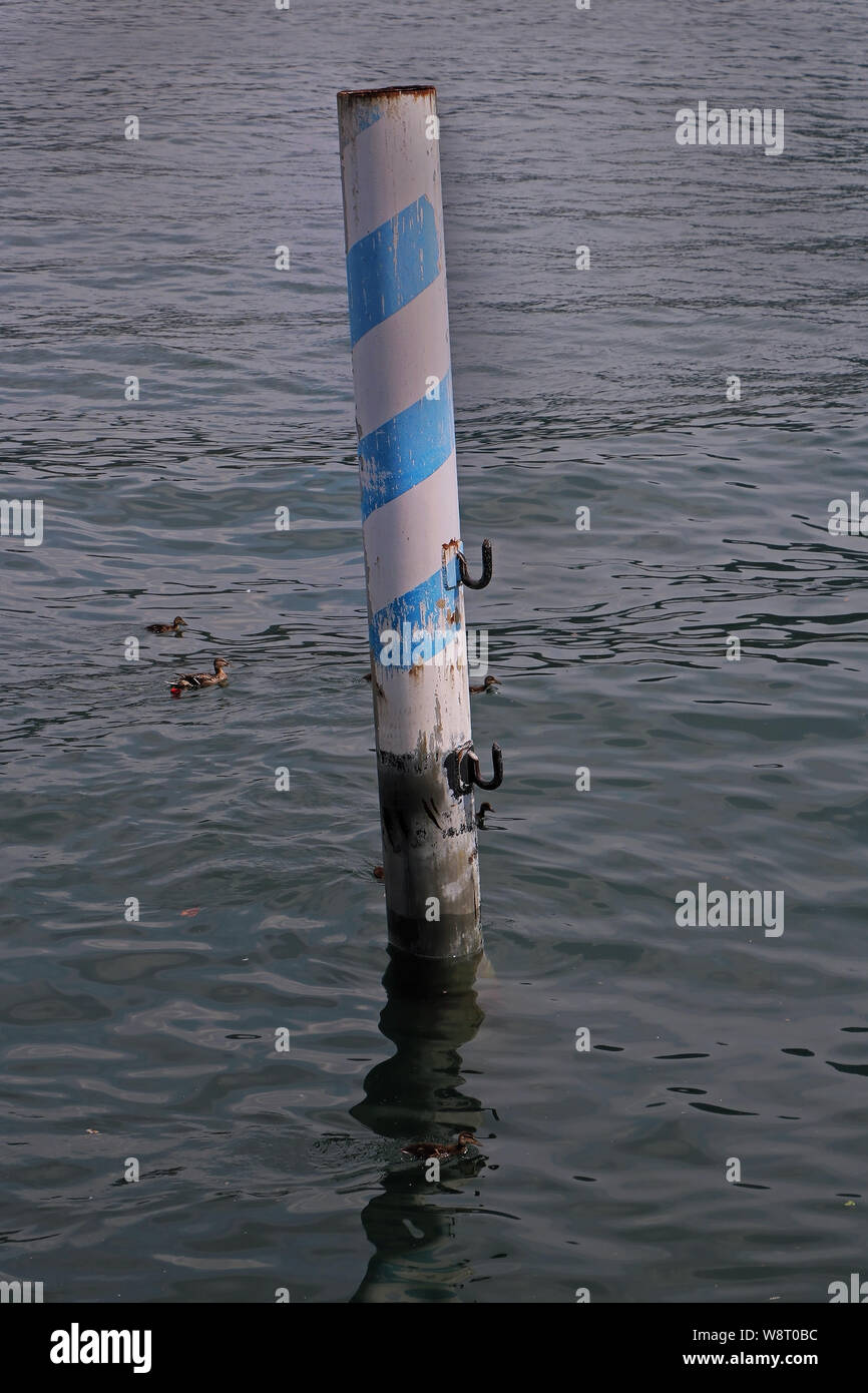 Metal pole in Venice canal water used for navigation Stock Photo - Alamy