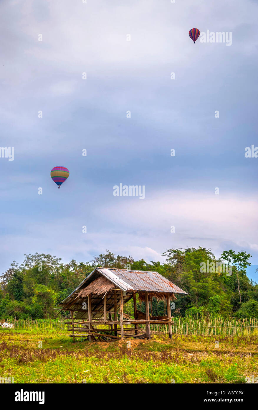 hot air balloon above the hut in rice paddy, Laos Stock Photo - Alamy