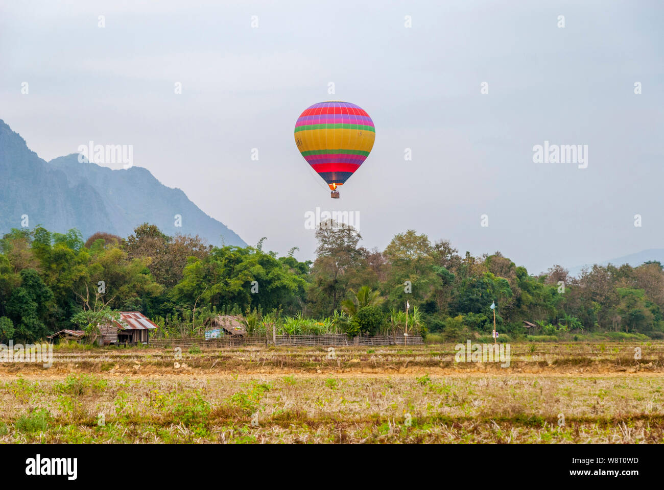 hot air balloon above the hut in rice paddy, Laos Stock Photo - Alamy