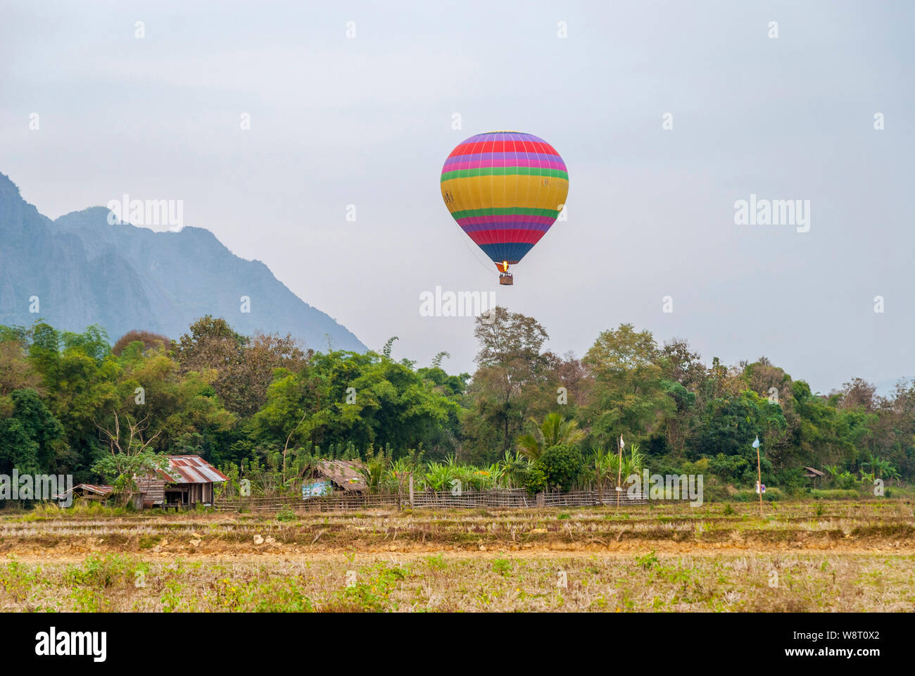 hot air balloon above the hut in rice paddy, Laos Stock Photo - Alamy