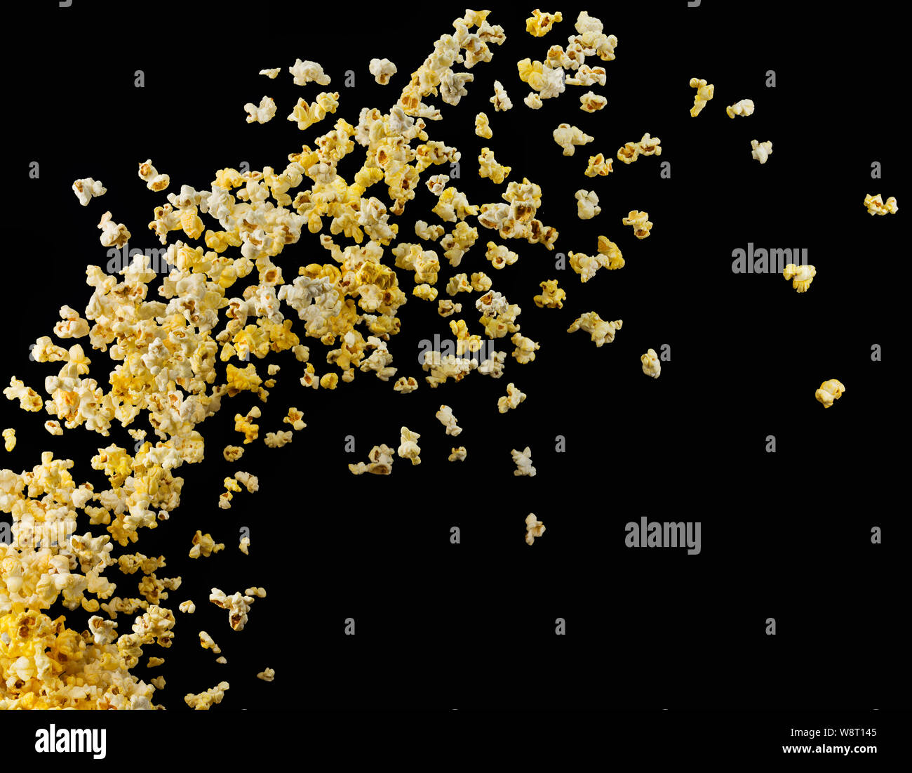 Flying popcorn or wave from it isolated on black background Stock Photo ...