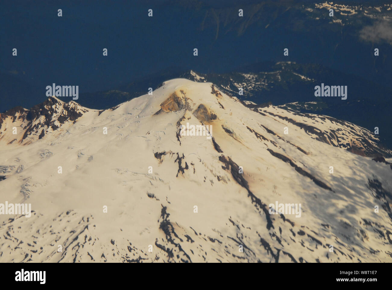 Beautifully snow covered Mount Rainier in the warm afternoon light ...