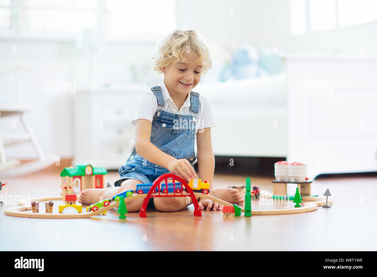 Kids play with wooden railway. Child with toy train. Educational toys ...