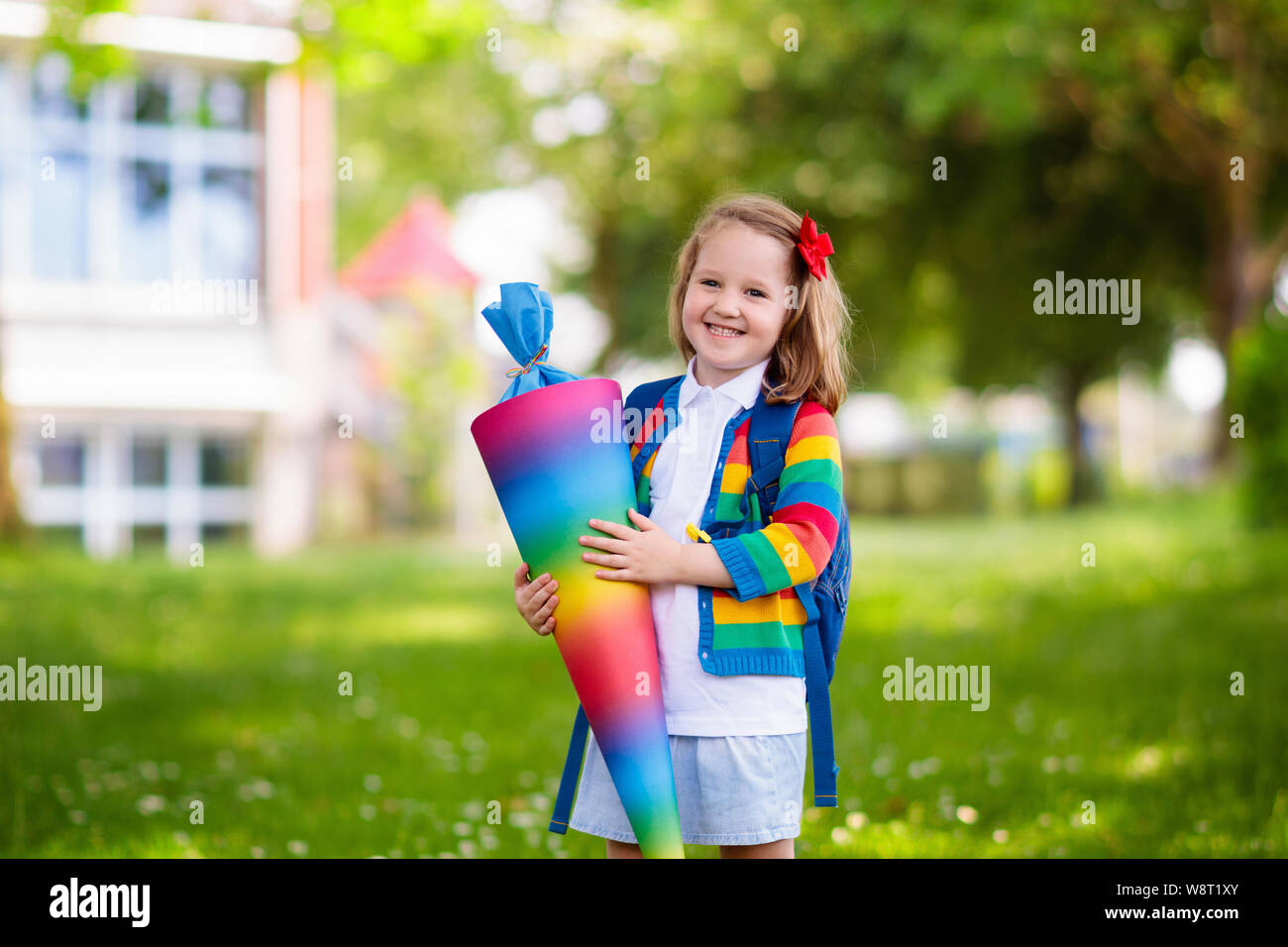 Happy child holding traditional German candy cone on the first school ...