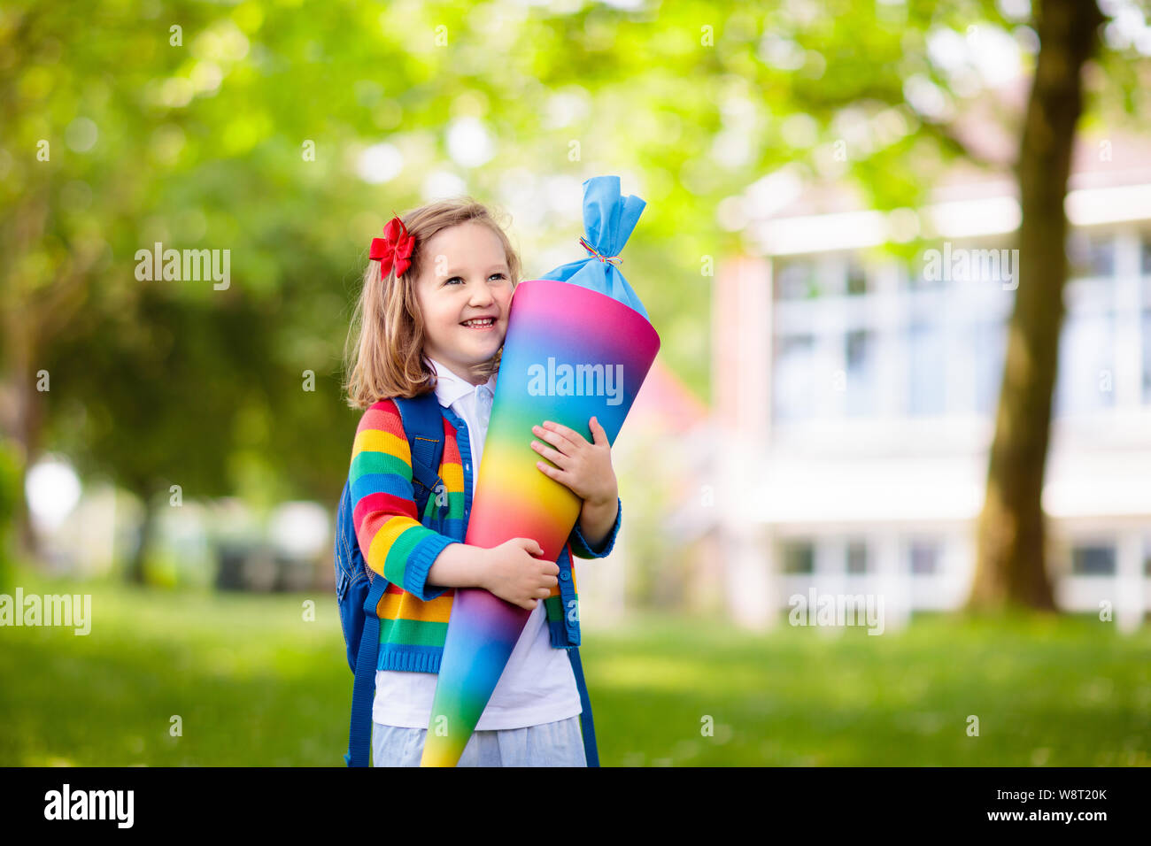 Happy child holding traditional German candy cone on the first school ...