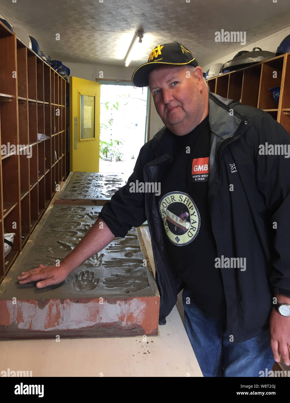 Steelworker and GMB shop steward Barry Reid, imprints his hand in wet ...