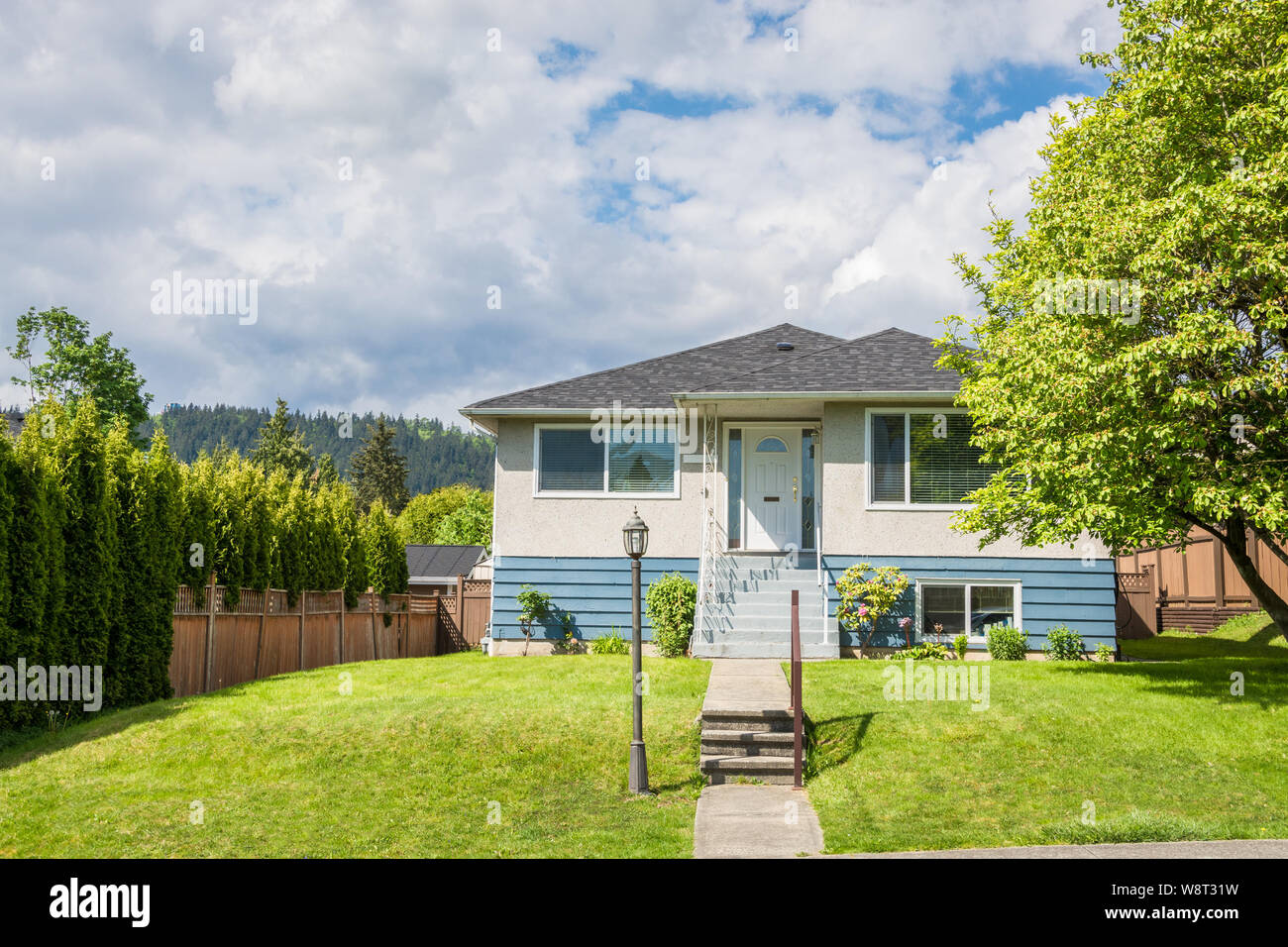 Average North American family house on cloudy sky background Stock ...
