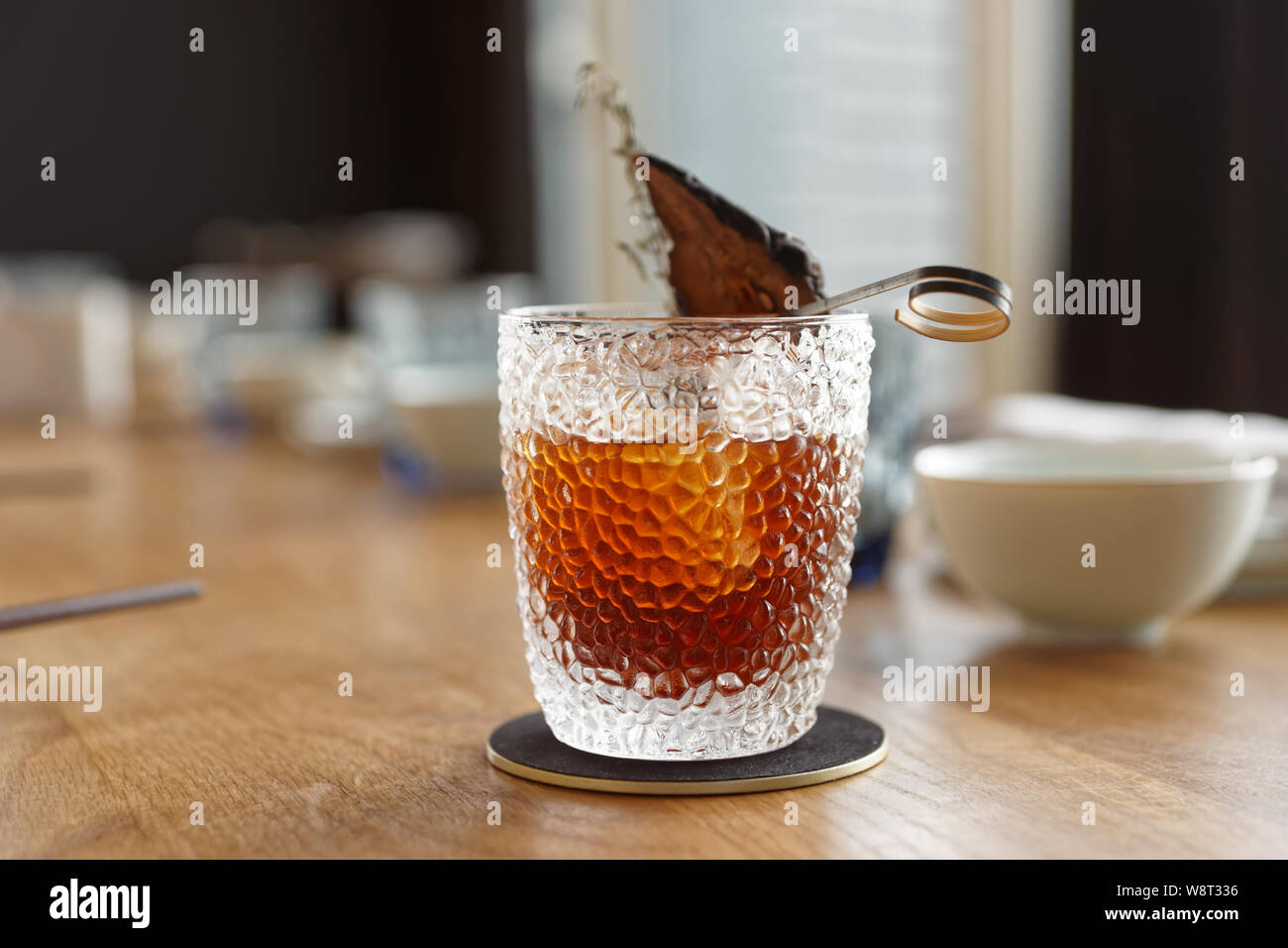 Tea-colored cocktail with dried pear, Asian style drink Stock Photo - Alamy