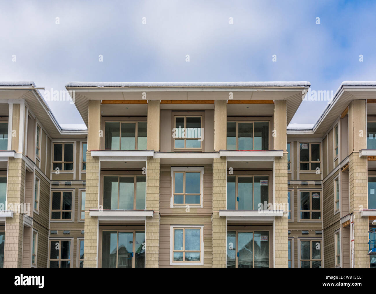 New low rise residential condo building on winter cloudy day in ...