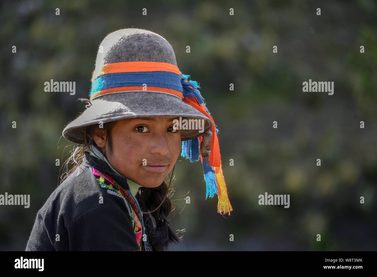 Indio girl with hat with colorful ribbons smiles, portrait, by Cusco ...