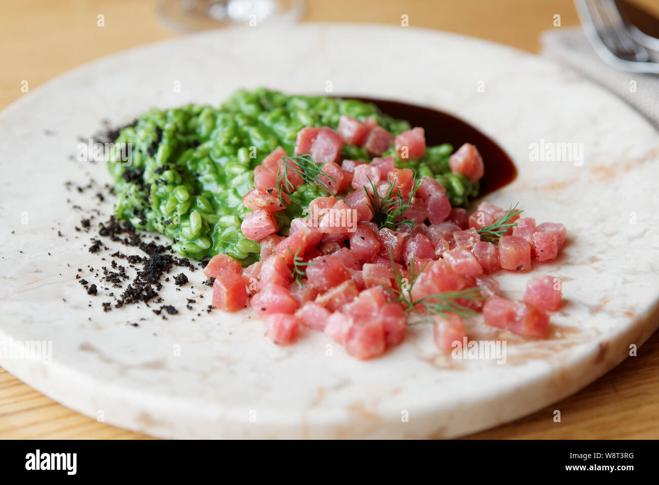 Bluefin tuna fillet, risotto with herbs and teriyaki sauce in marble ...