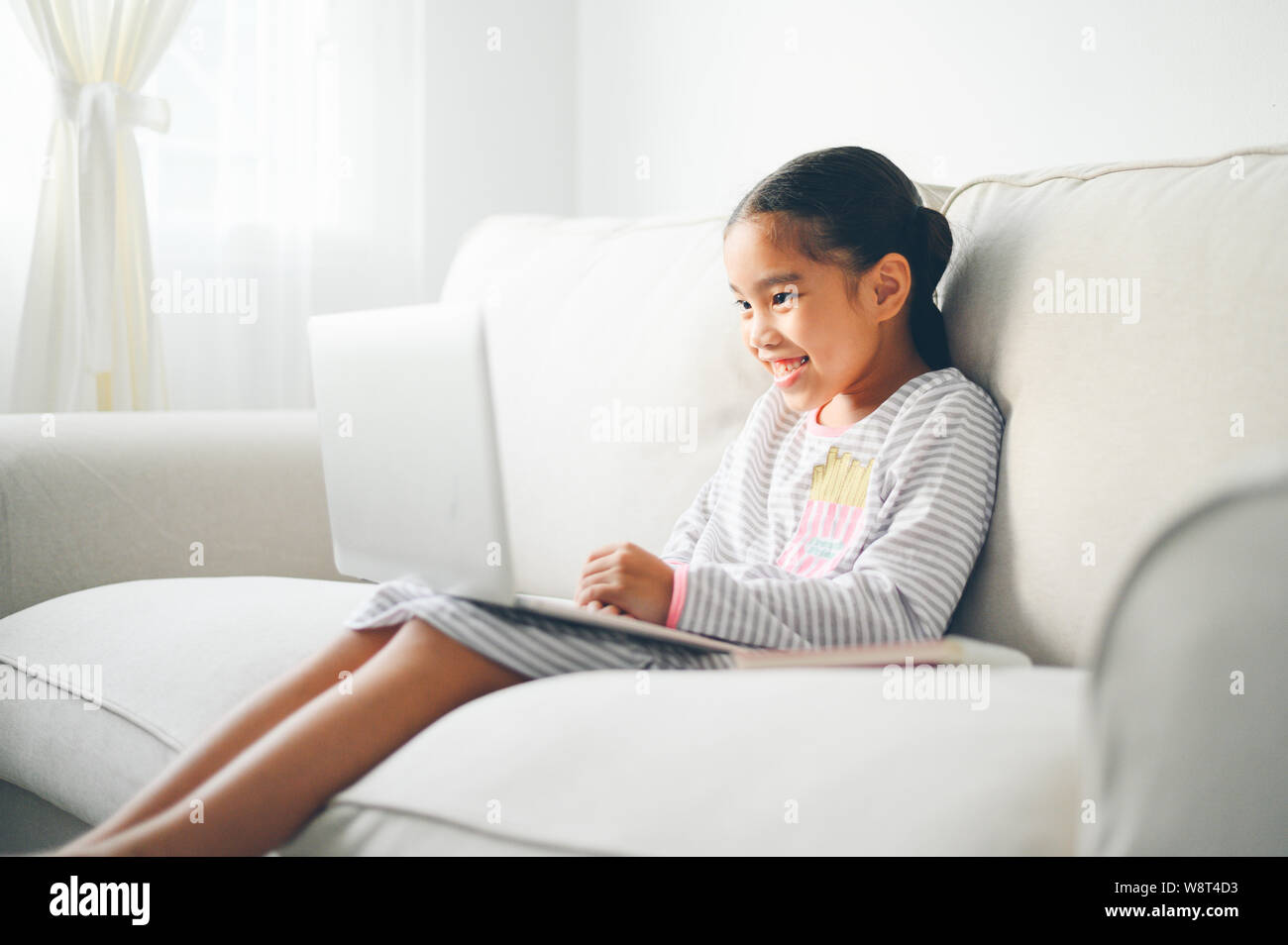 Back to School. asian Little girl using his laptop Stock Photo - Alamy