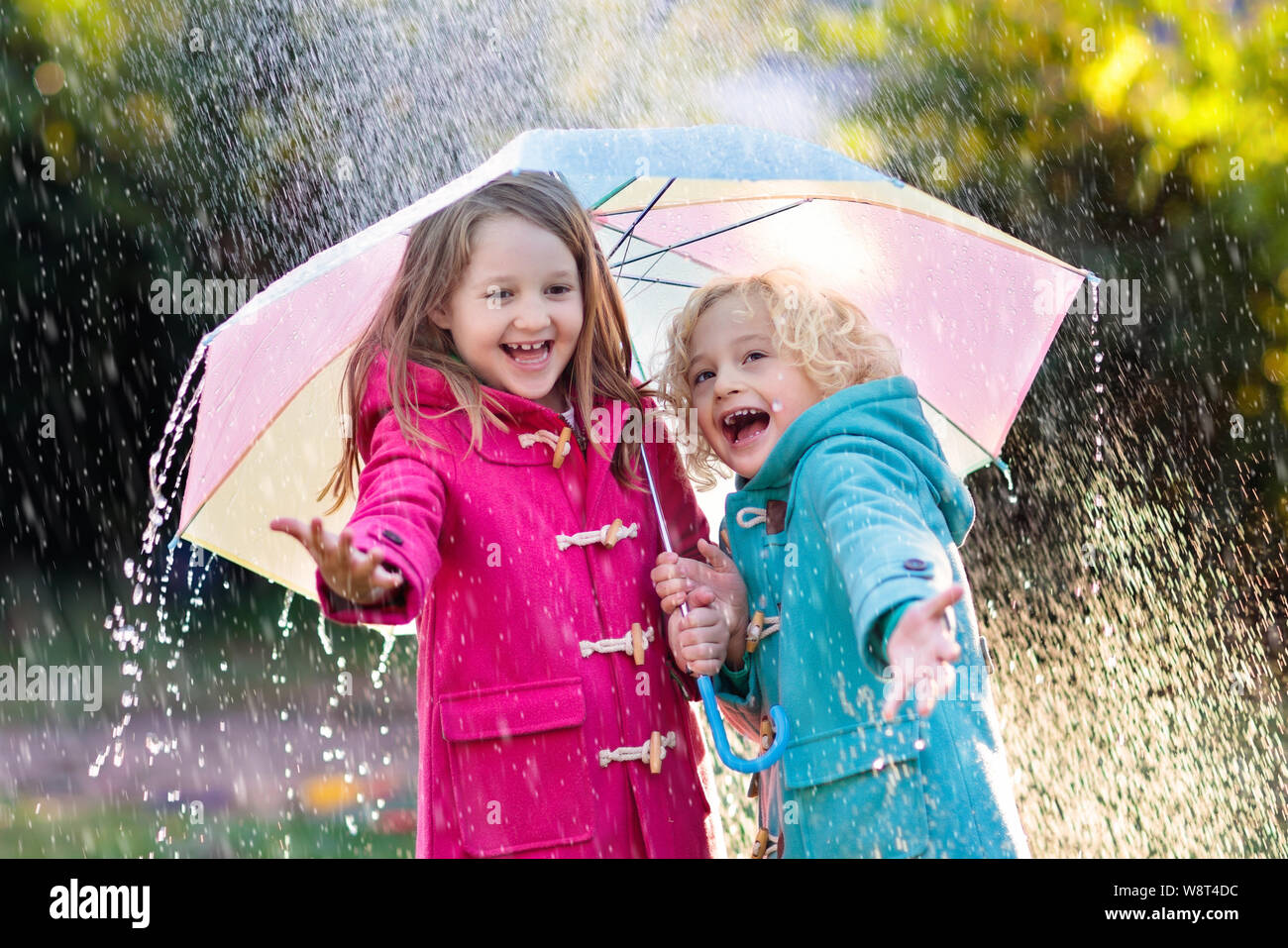 Little Boy And Girl In The Rain