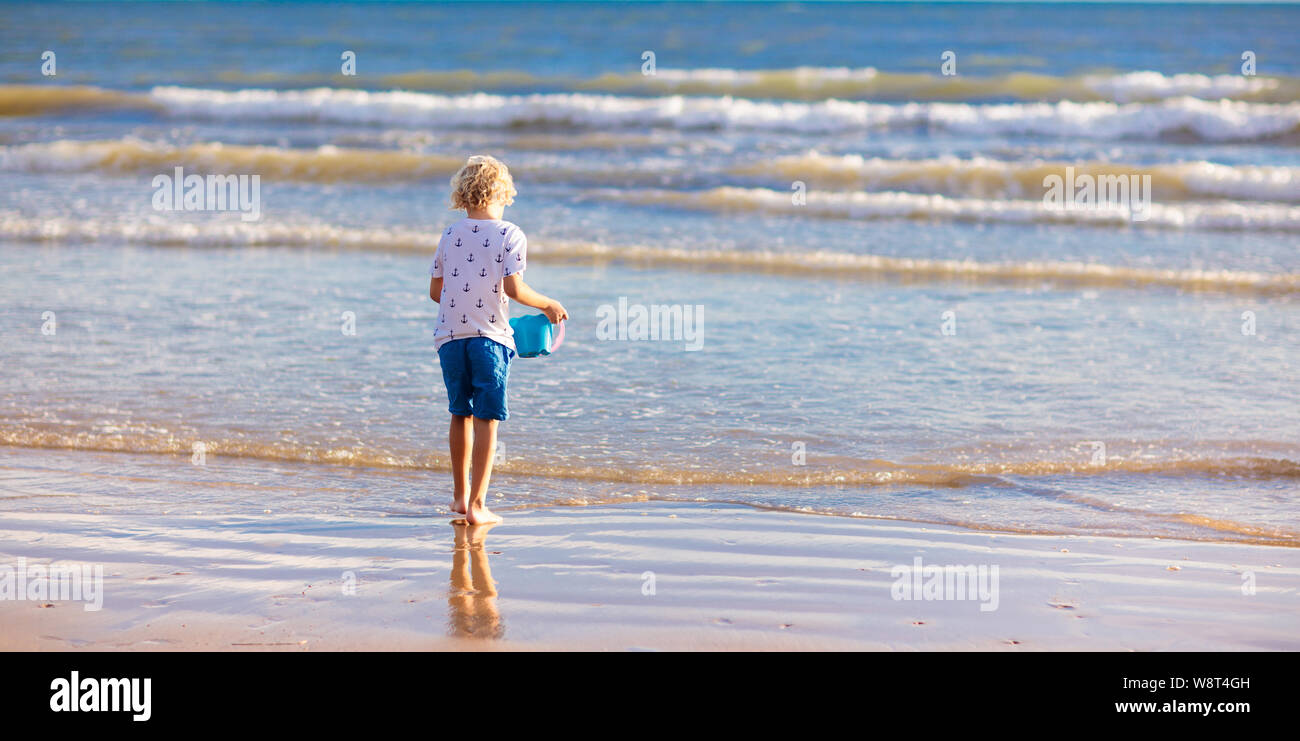 Boy playing with shells hi-res stock photography and images - Alamy