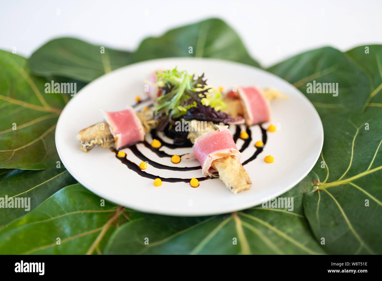 A beautiful, well presented food course on a white table Stock Photo ...