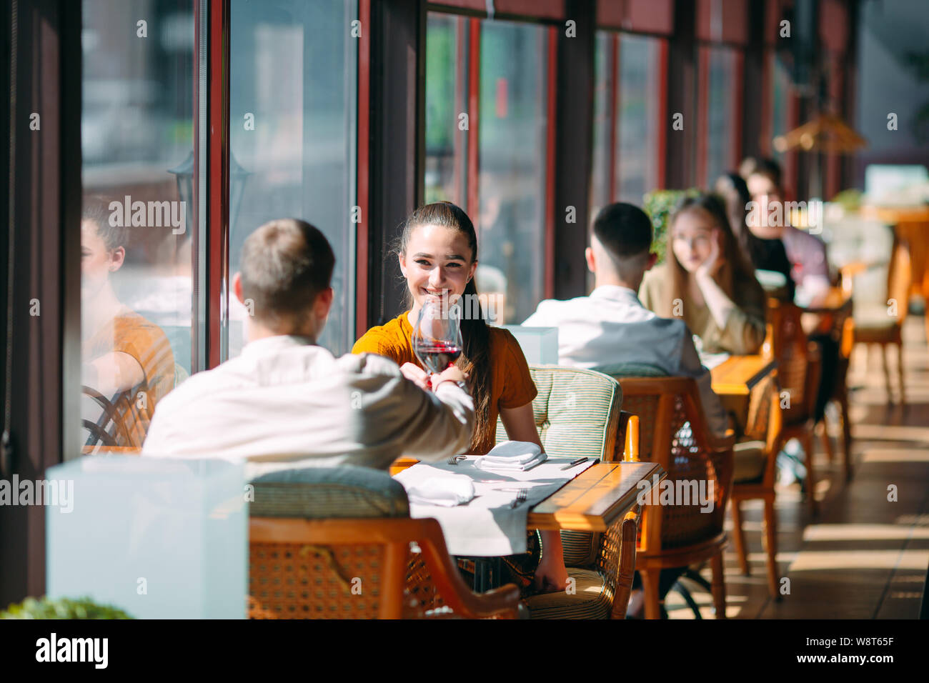 A young couple drinking wine in a restaurant near the window Stock ...