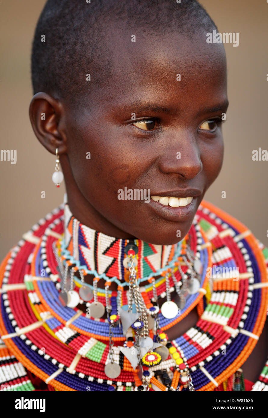 Young beautiful Maasai woman with traditional necklace poses for a ...