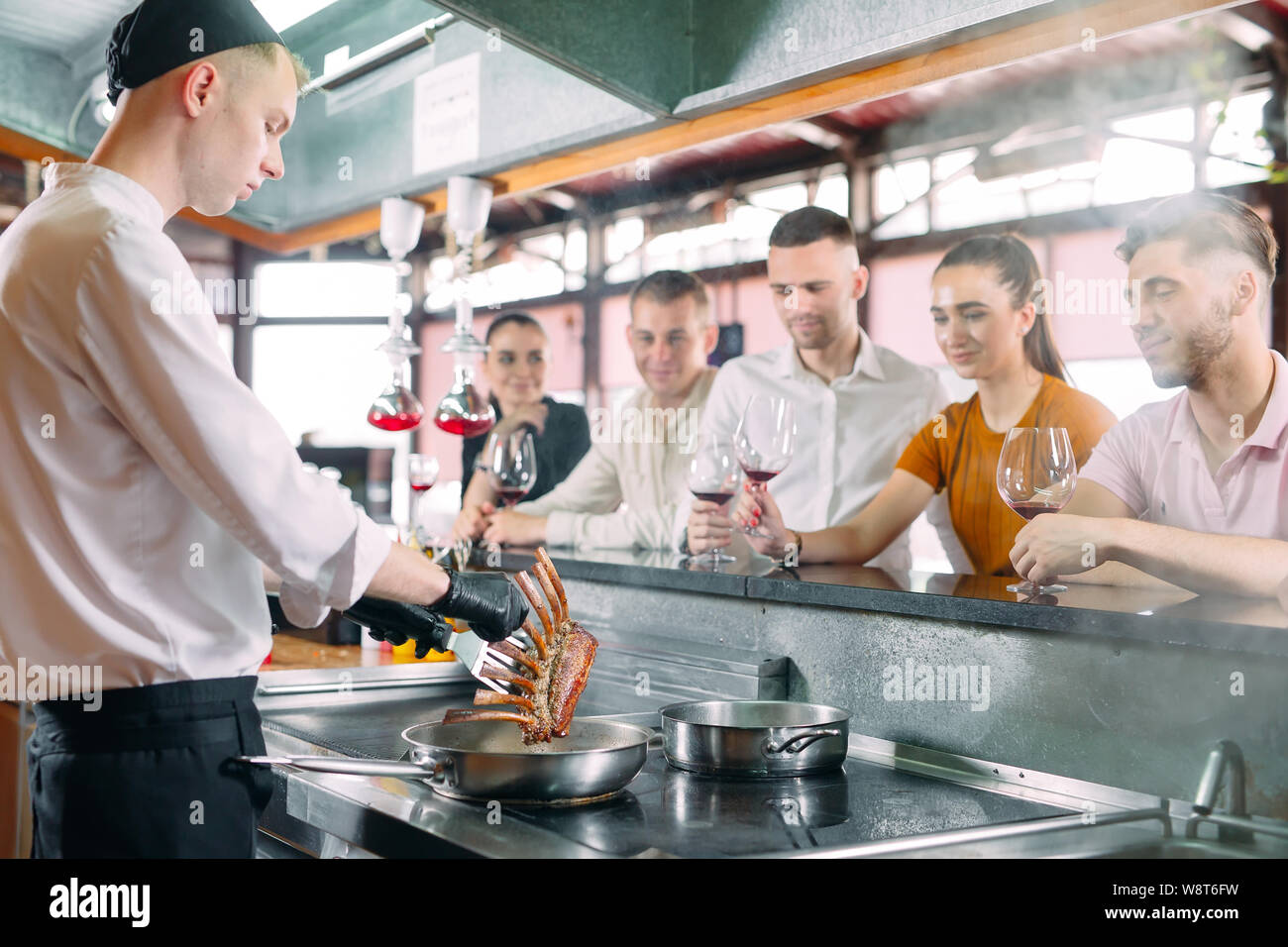 The chef prepares food in front of the visitors in the restaurant Stock ...