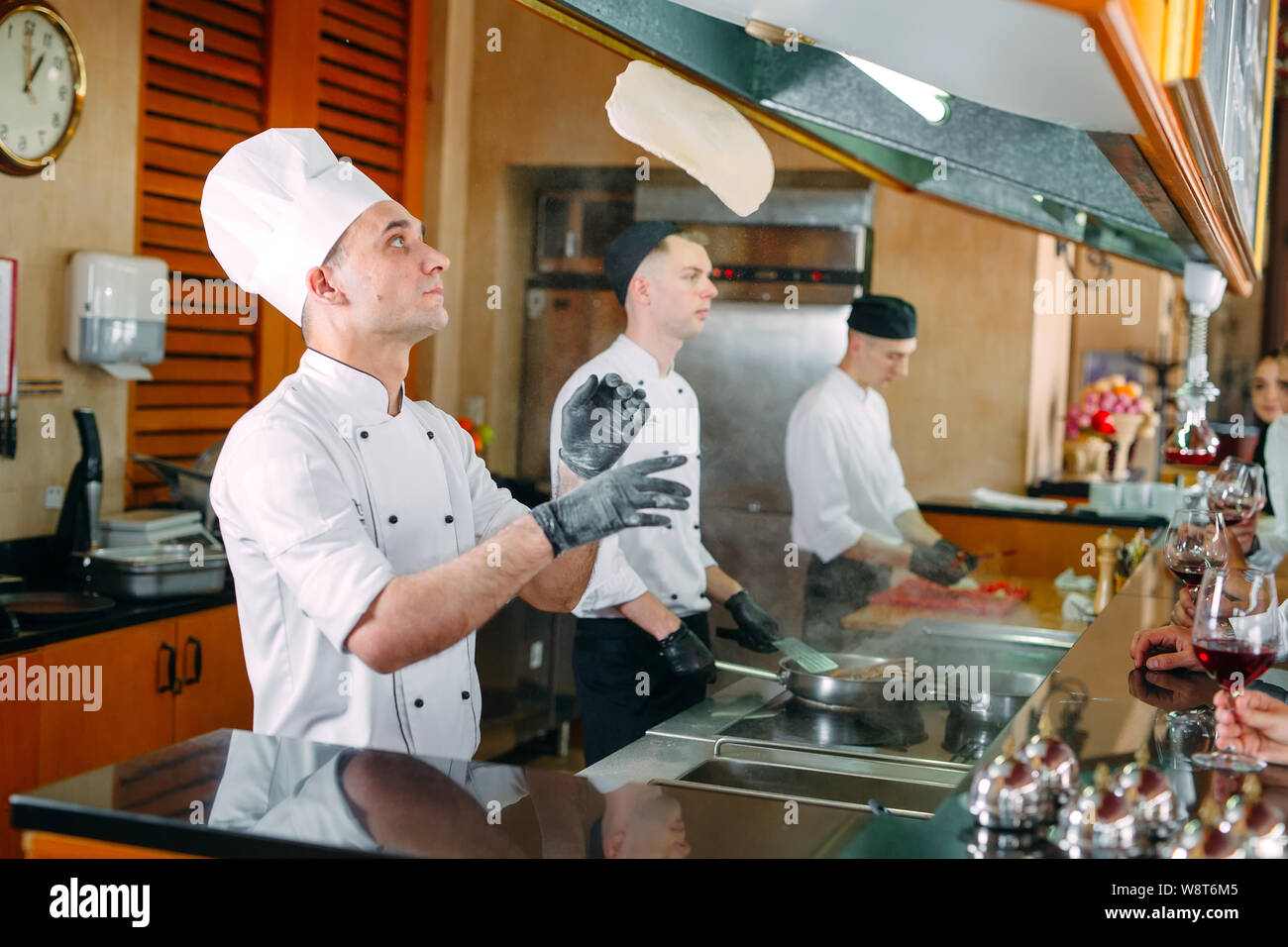 The chef prepares food in front of the visitors in the restaurant Stock ...