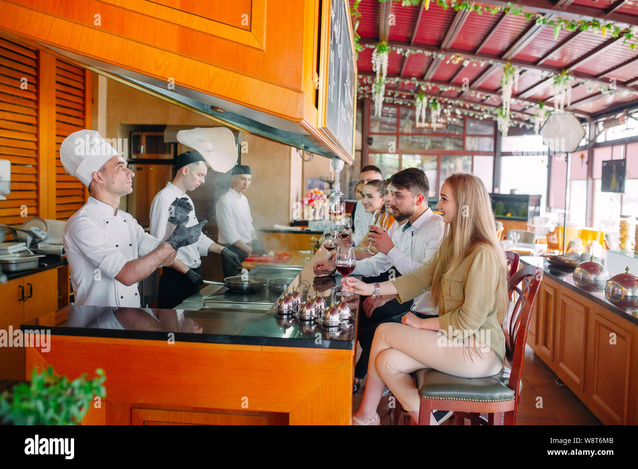 The chef prepares food in front of the visitors in the restaurant Stock ...