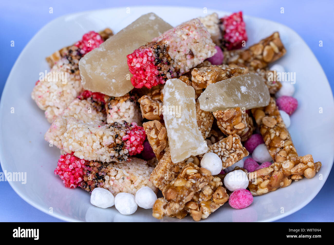 Thai sweet cereal bar made of rice, nut, sesame seeds and sugar on ...