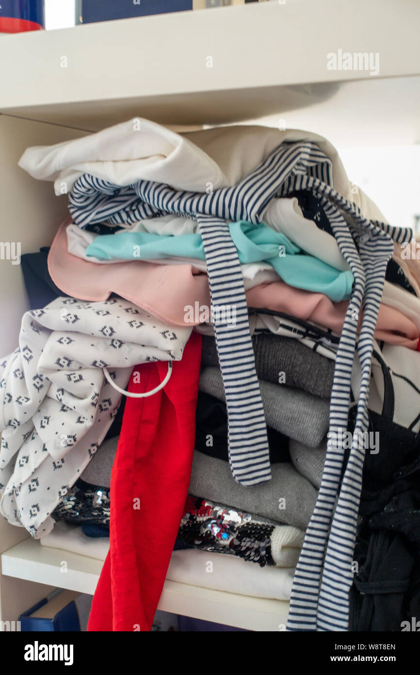 Students clothes on bedroom shelf Stock Photo - Alamy