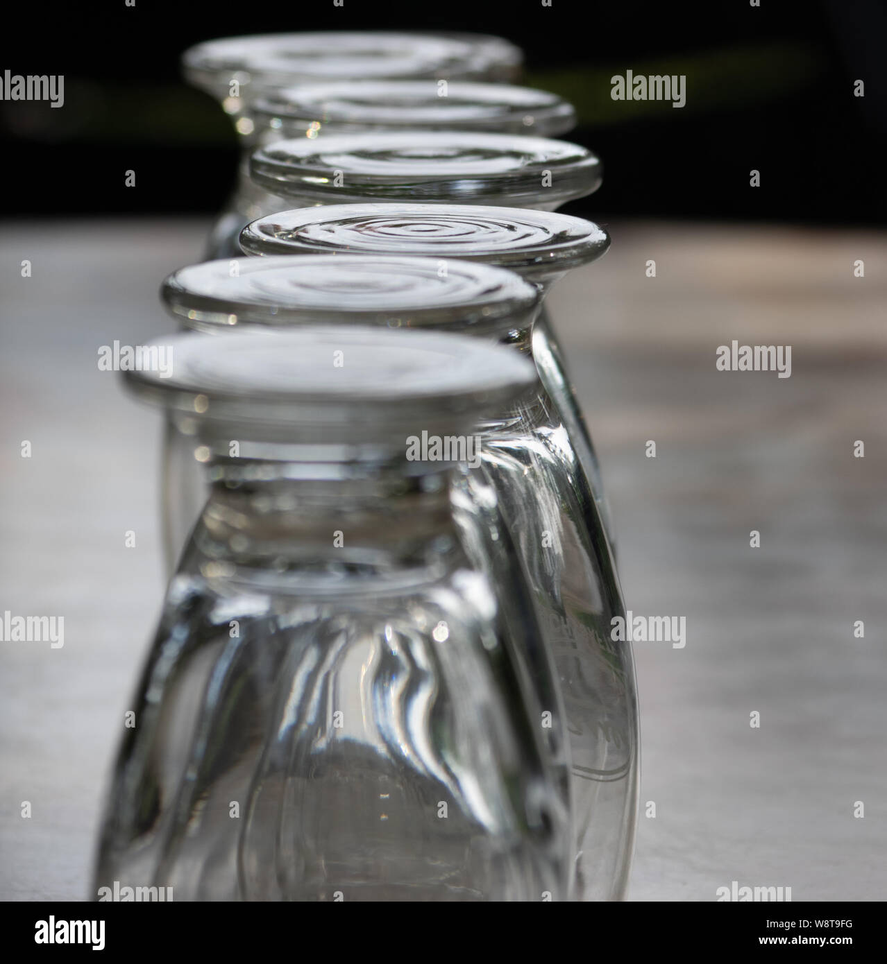 close up row of glasses turned upside down on a table Stock Photo - Alamy