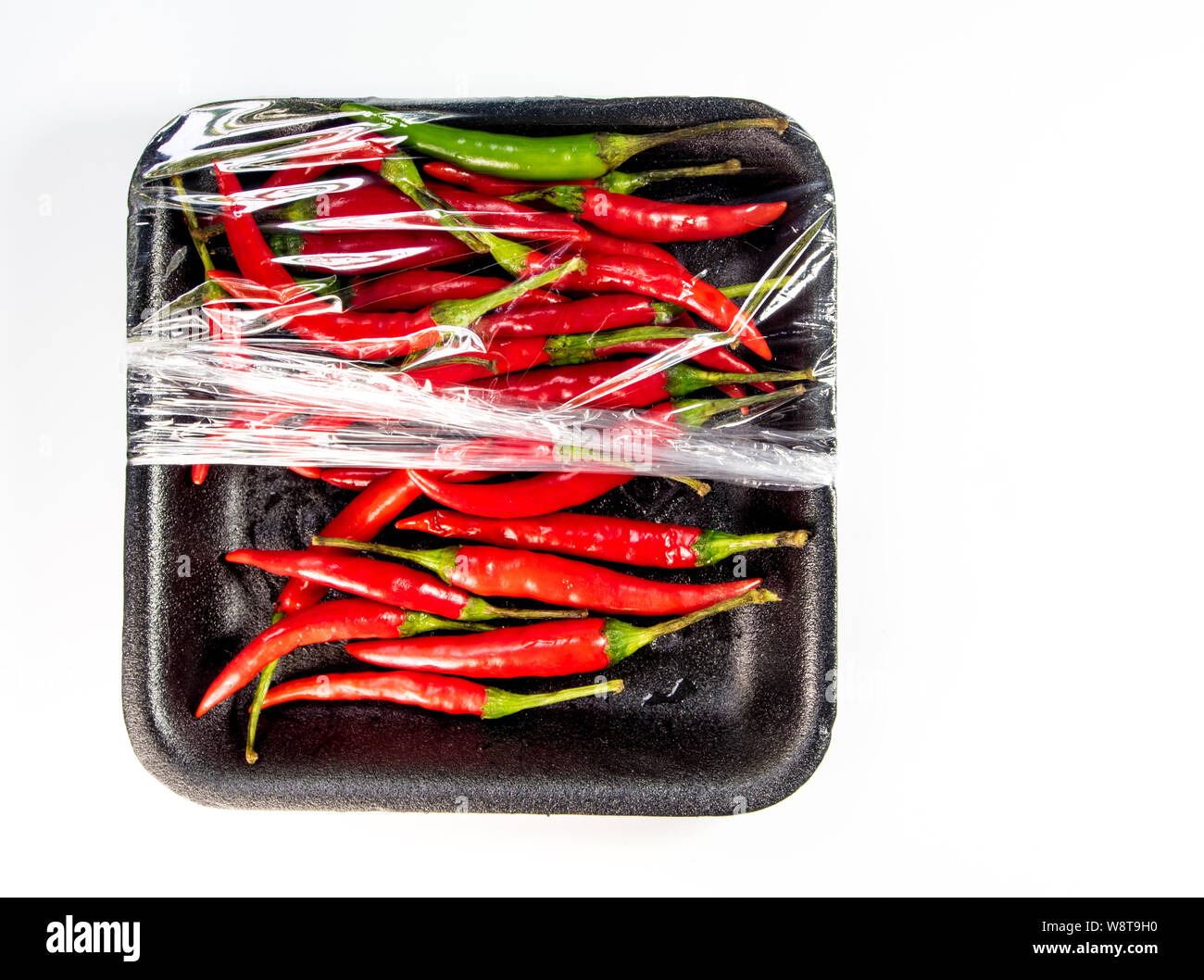 Red chili in foam and plastic package Stock Photo - Alamy