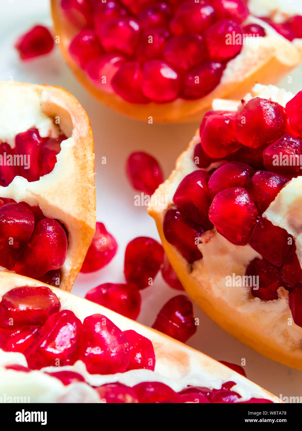 Top view closeup of red pomegranate seeds on pomegranate seeds pile ...