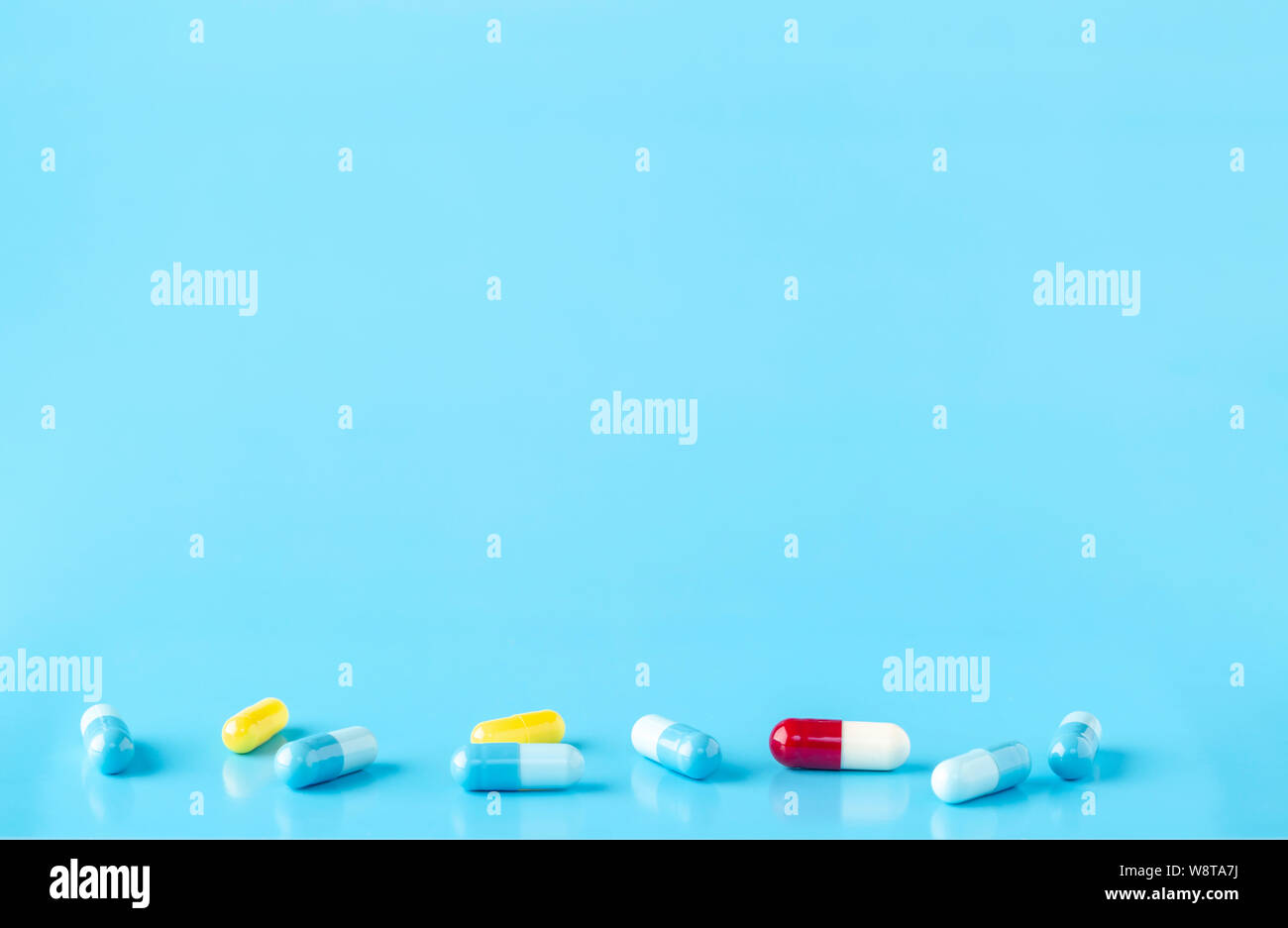 Various medication capsules. Blue background with text space Stock ...