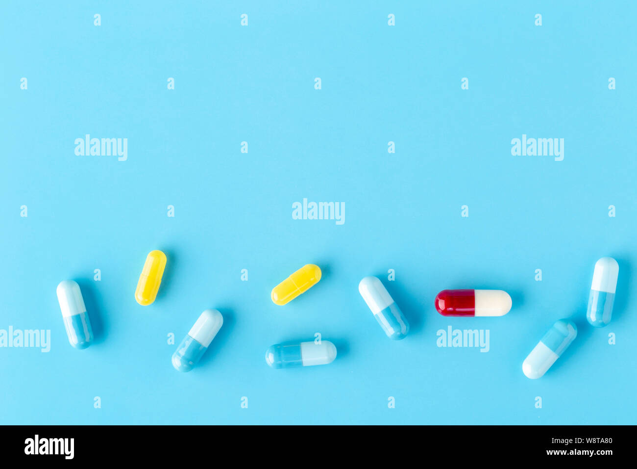 Various medication capsules. Blue background with text space Stock ...