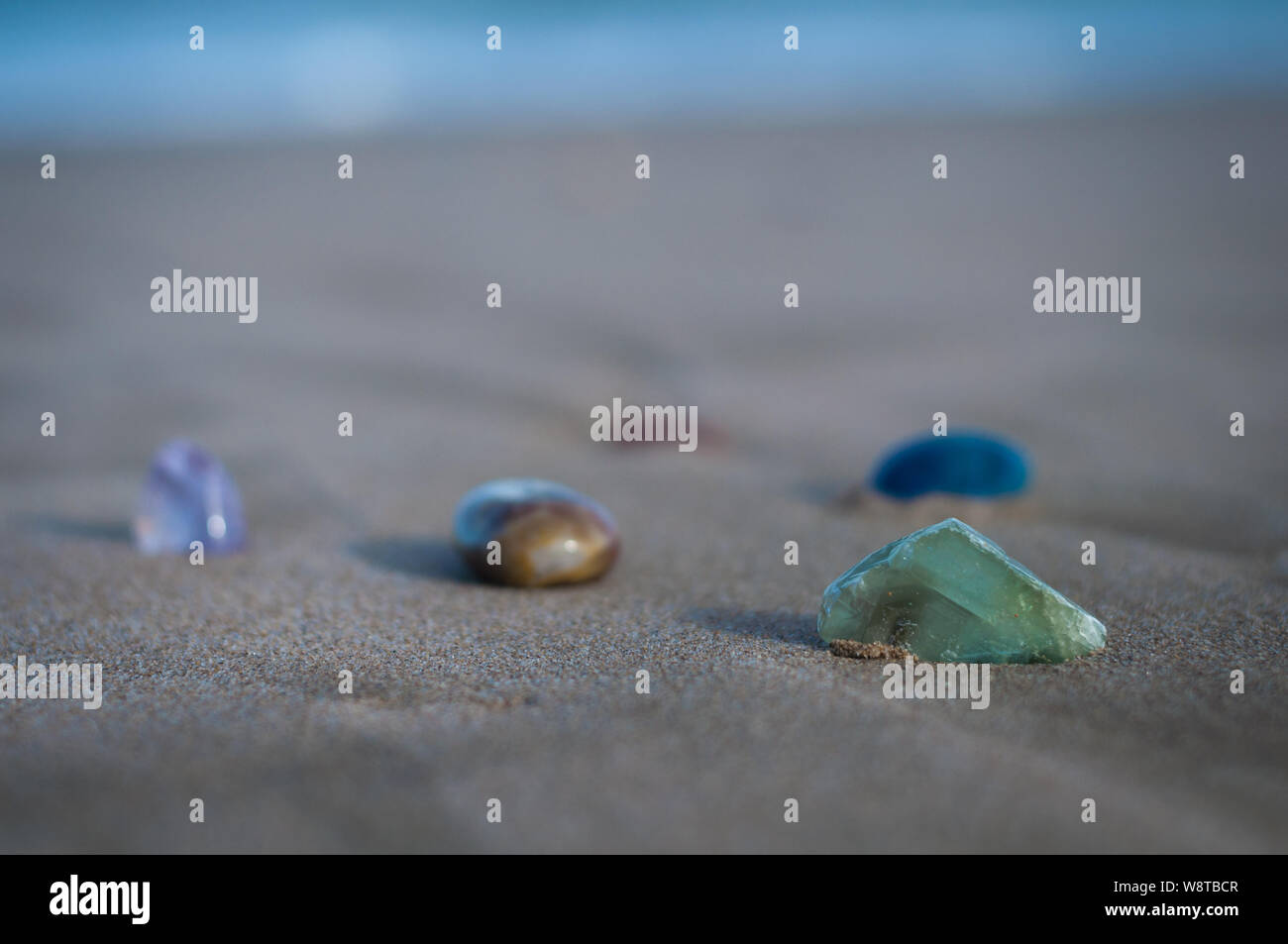 colored minerals on the stone beach in bulk Stock Photo - Alamy