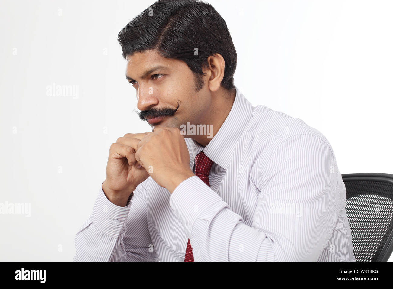 Head shot thinking touching chin hi-res stock photography and images ...
