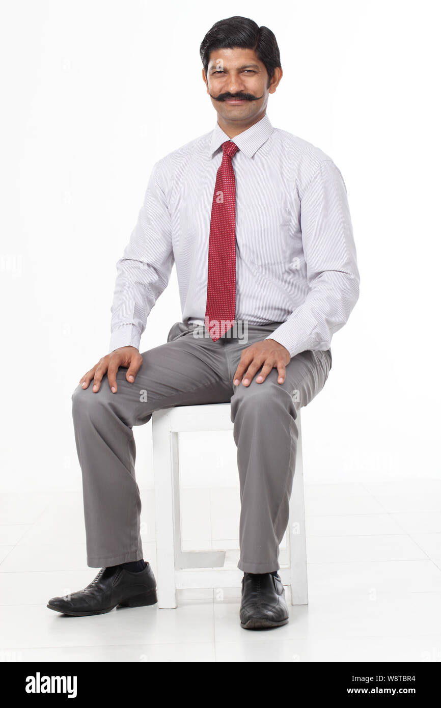 Employee sitting on stool hi-res stock photography and images - Alamy