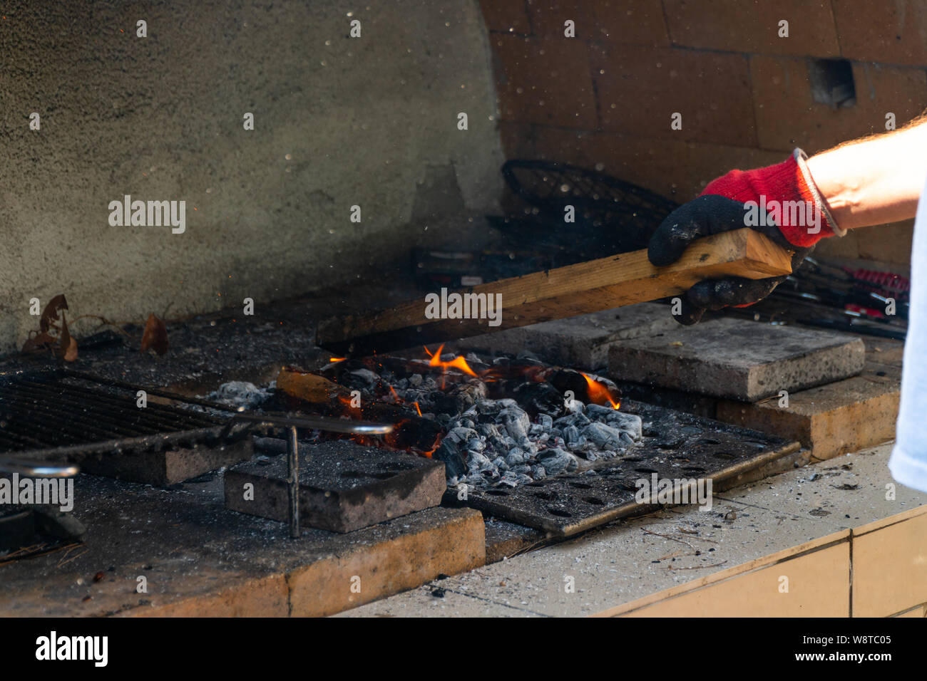 fire in a barbaque, setting fire on coal barbacue Stock Photo - Alamy