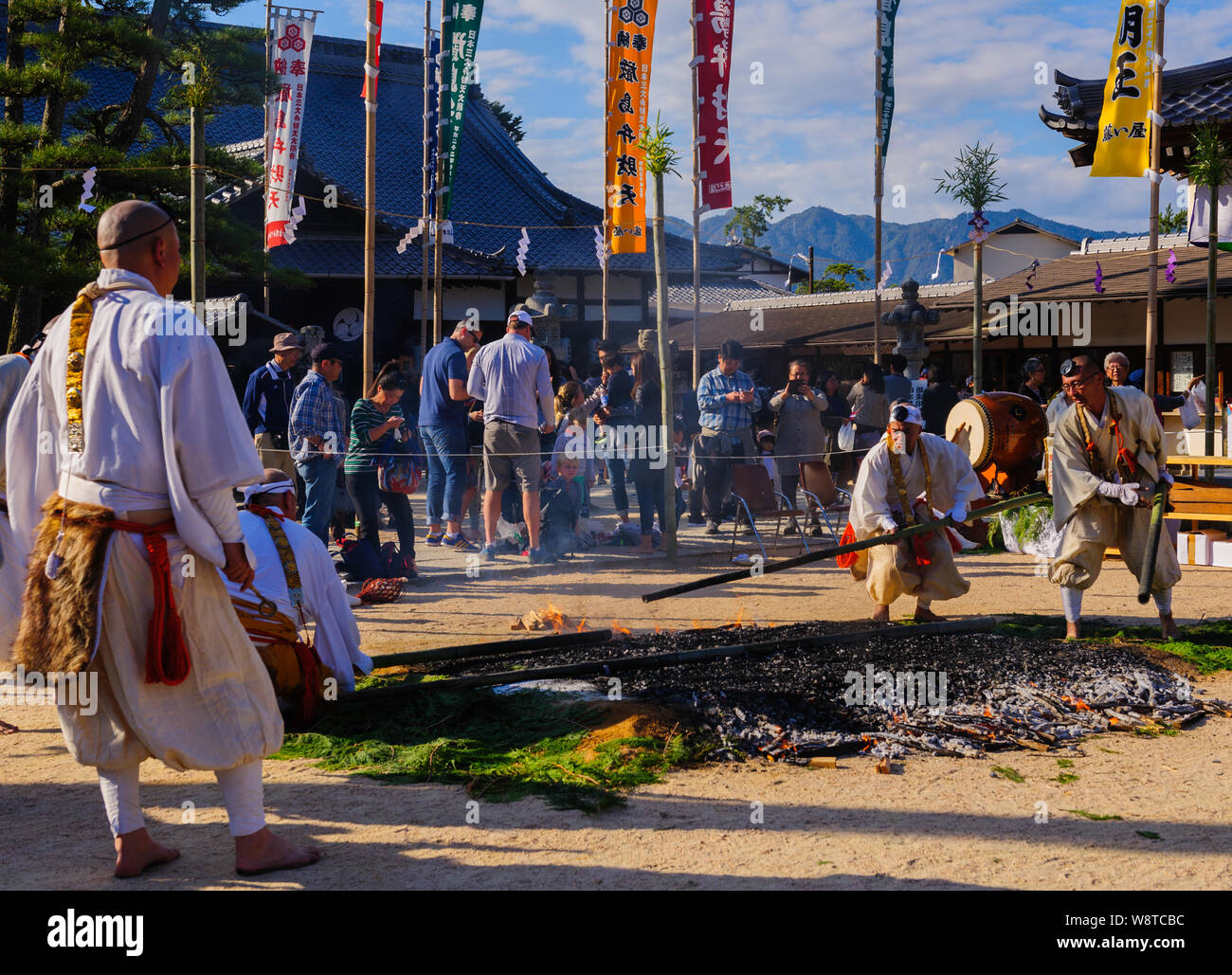 Buddhistic shintoistic ceremony of firewalk with people walking ...