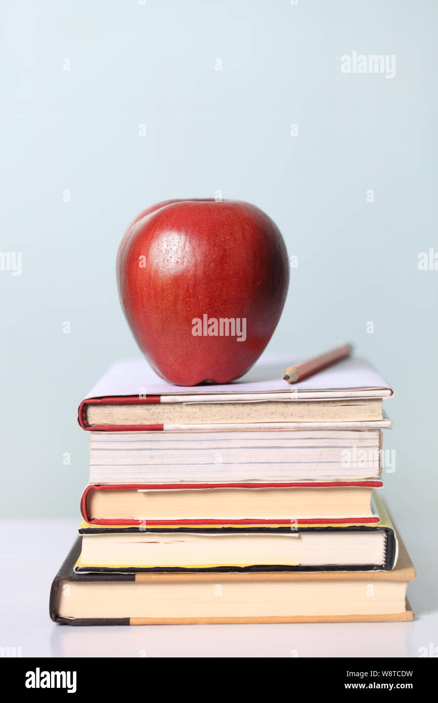 Apple on top stacked books hi-res stock photography and images - Alamy