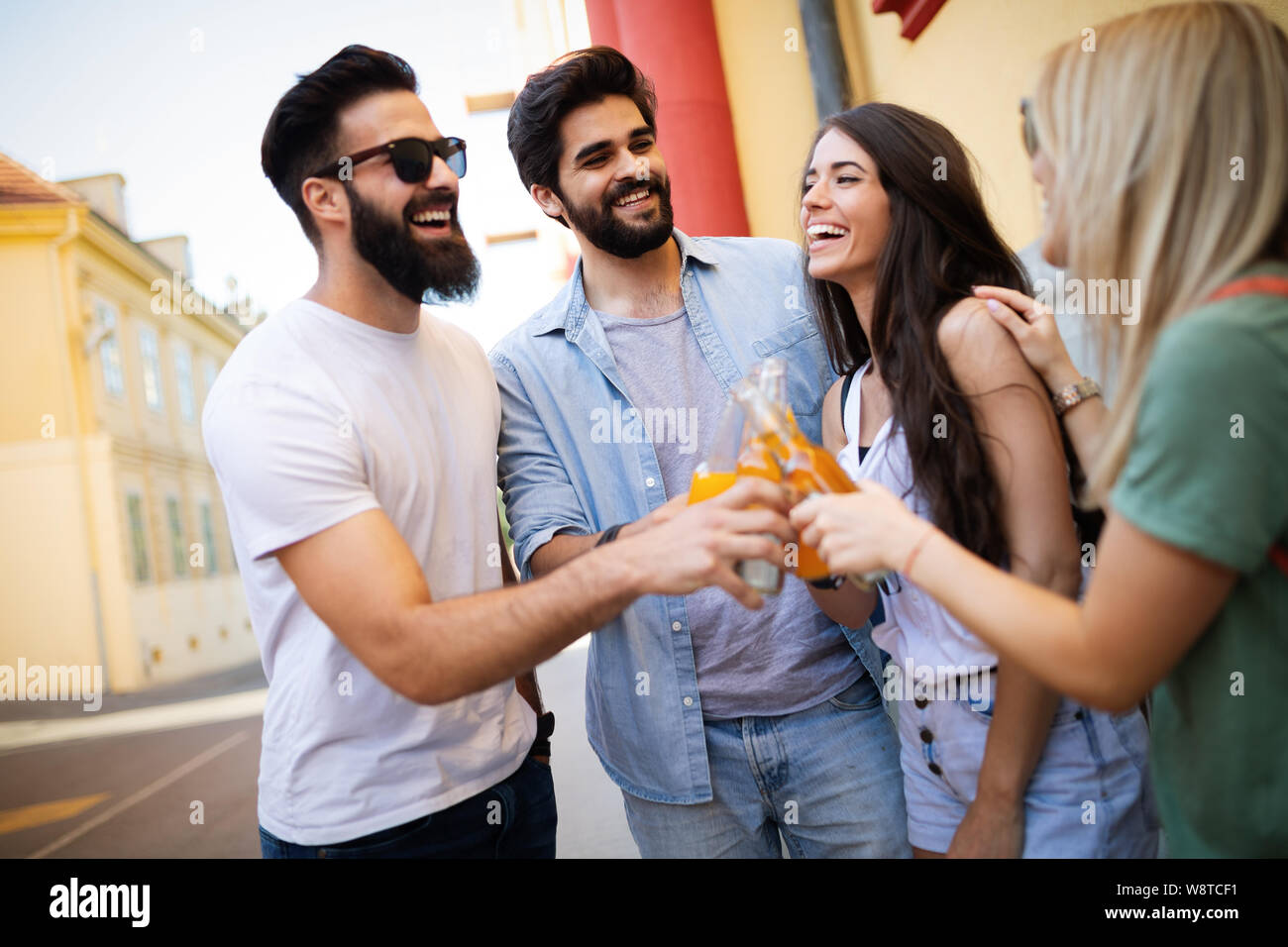 Group of friends having fun and hanging out outdoors Stock Photo - Alamy