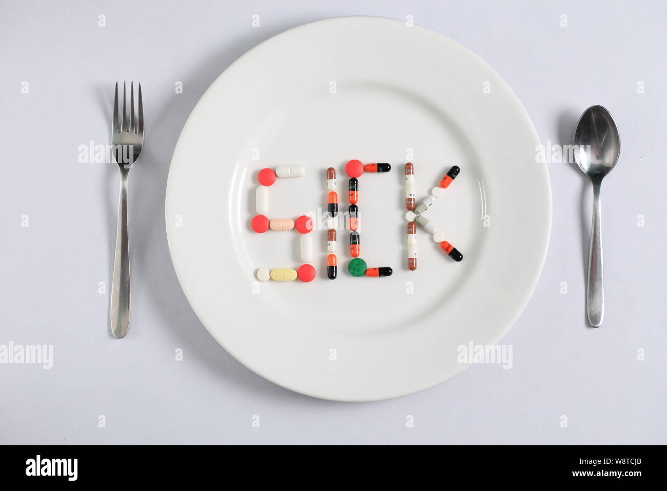 Assorted medicines served in a plate and making a word SICK Stock Photo ...