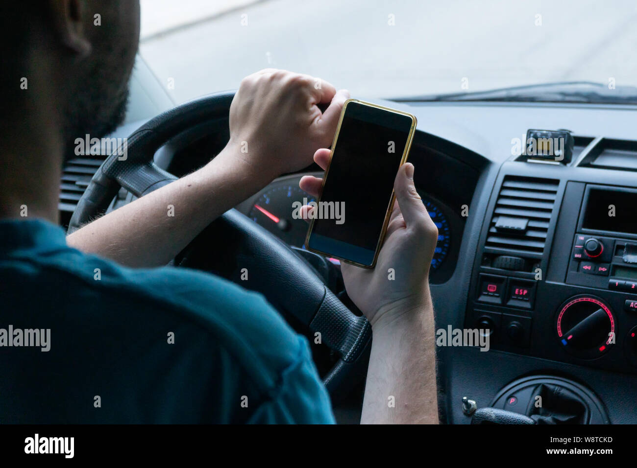 Man using smartphone while driving the car - transportation and vehicle ...