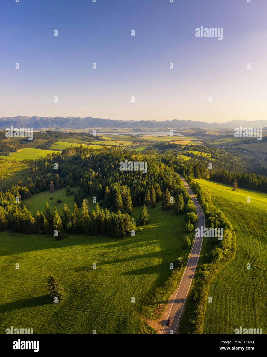 Road going through forests and villages of the Liptov region in ...
